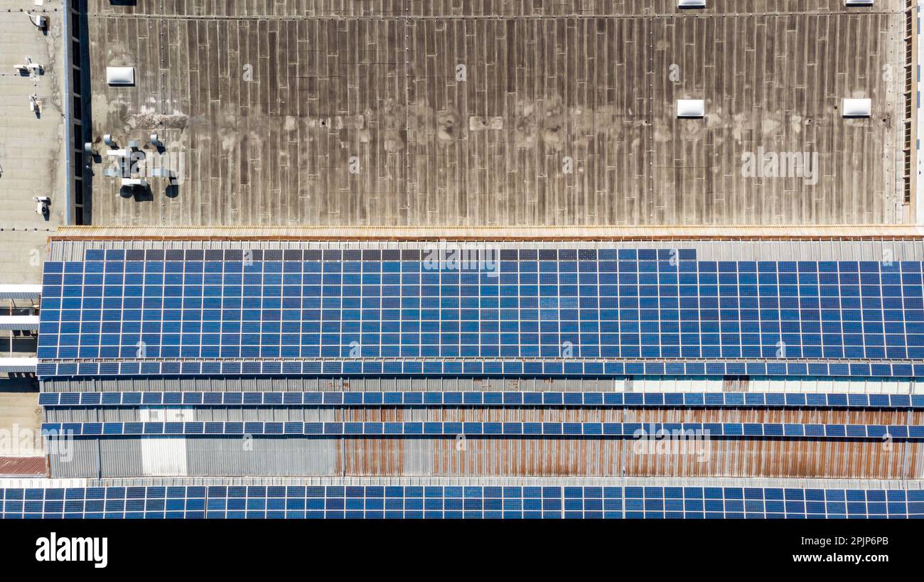 Drop down view of solar power plant with panels placed on industrial ...