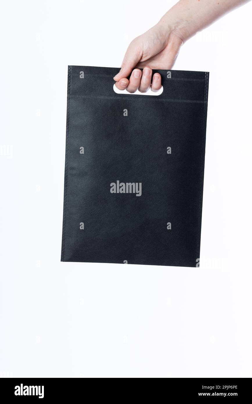 Hand holding black bag hi-res stock photography and images - Alamy
