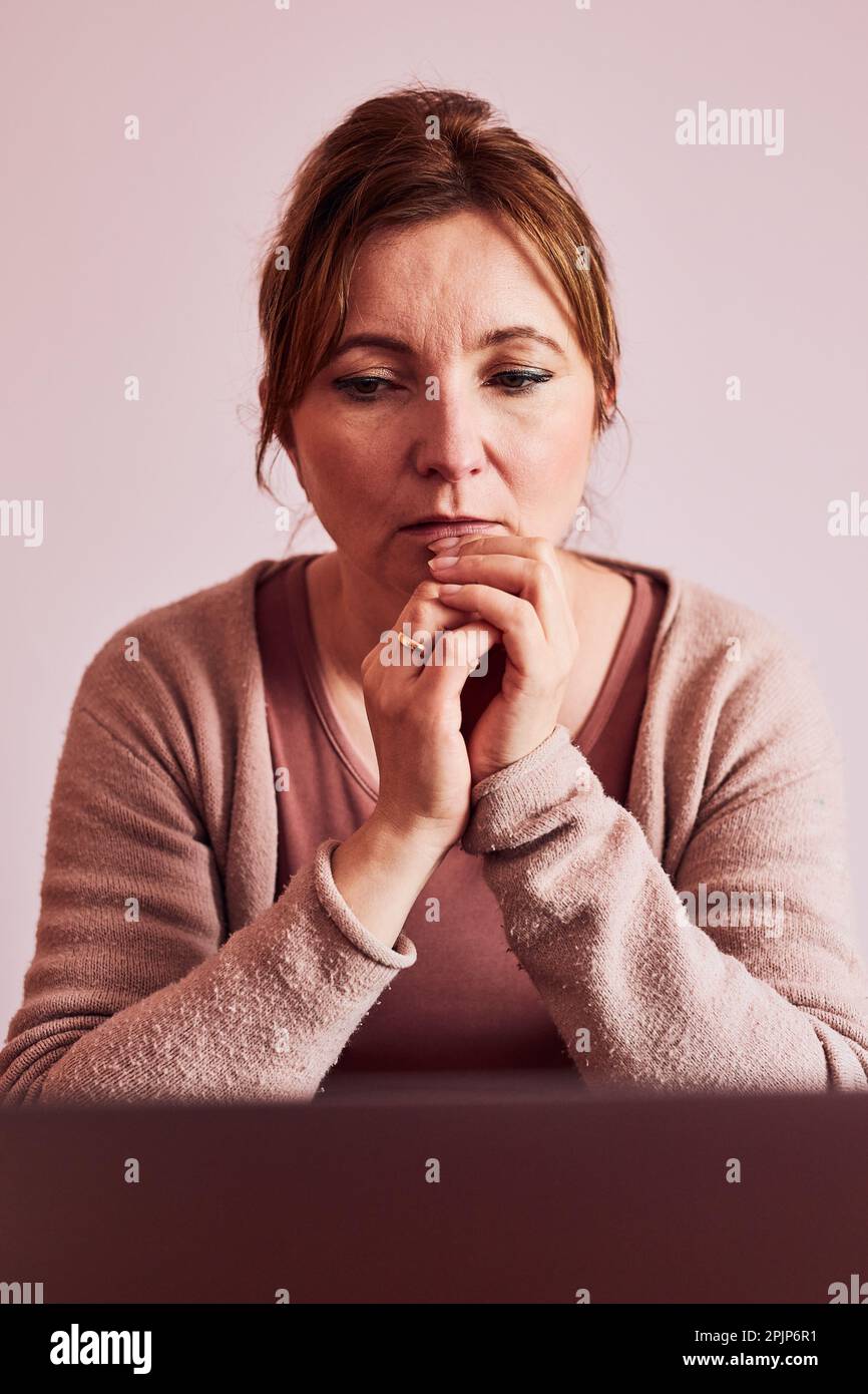 Woman focused on her work working hard doing her job remotely on laptop ...