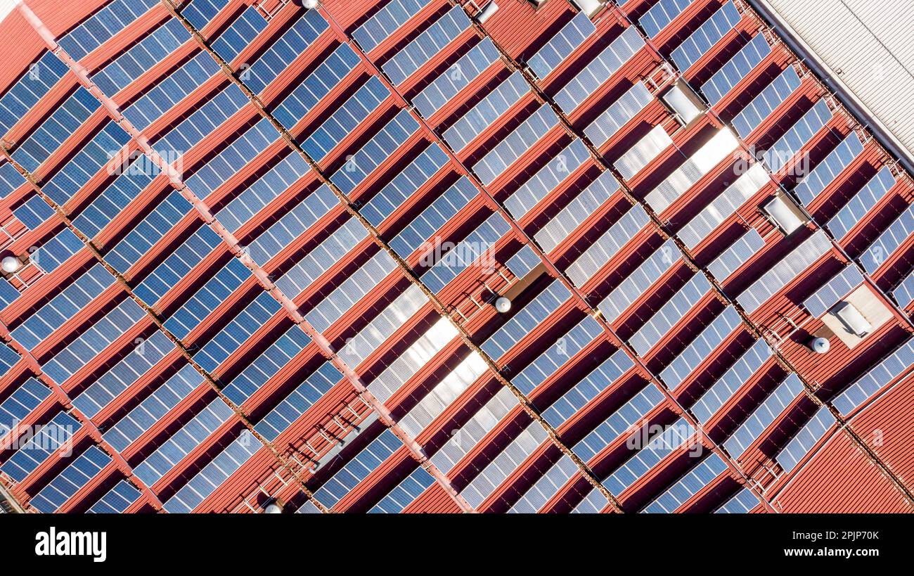 Drop down view of solar power plant with panels placed on industrial ...