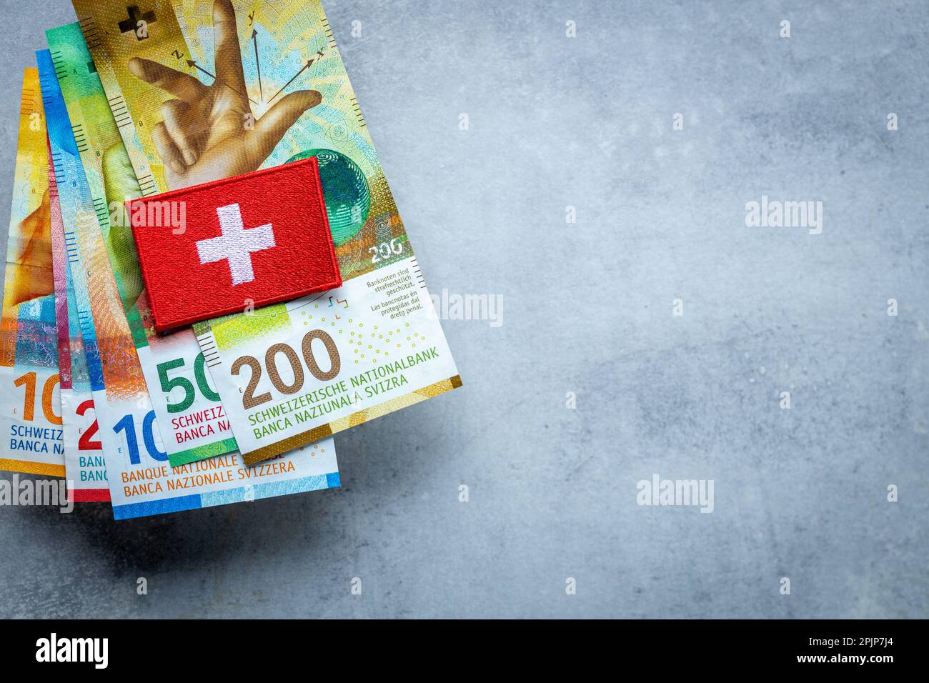 Swiss flag lying on a stack of Swiss francs, Currency of Switzerland ...