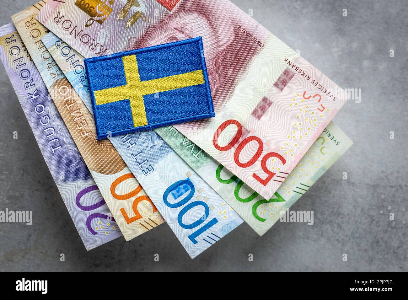 Sweden flag lying on a bundle of swedish kronas, Currency of Sweden ...
