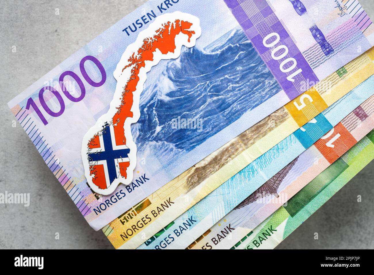 Norwegian money on a gray table top all banknotes, Norway flag ...