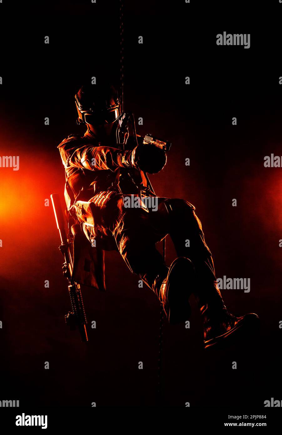 Silhouette of police officer in tactical gear descending from a height ...
