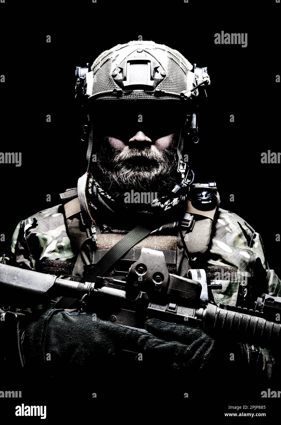 Close up, low key half length portrait of bearded commando fighter ...