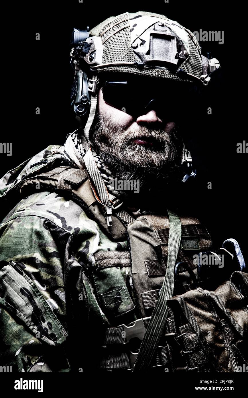 Close up, low key half length portrait of bearded commando fighter ...