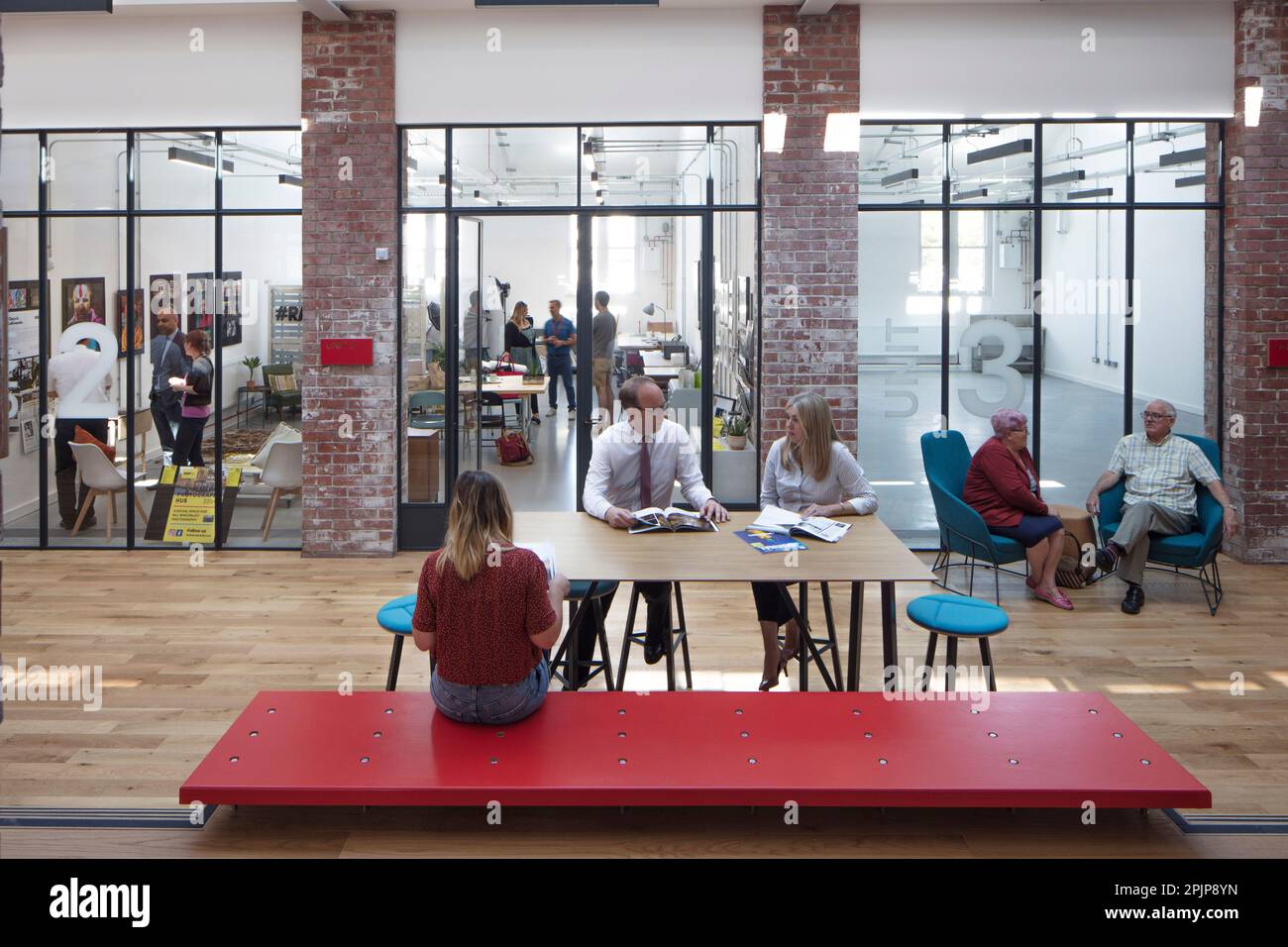 People using the main communal meeting space, with a view looking ...