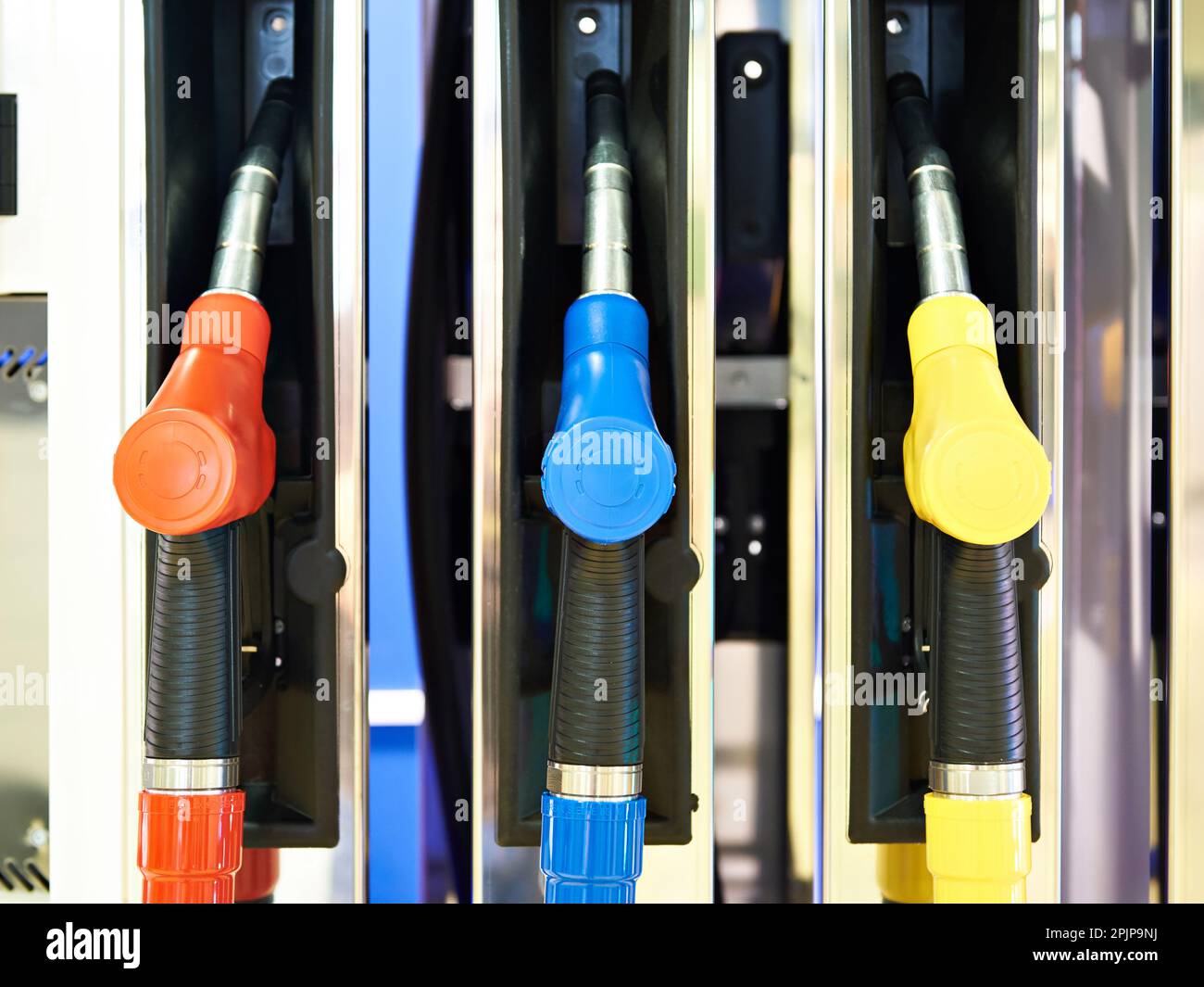 Fuel nozzles on filling station Stock Photo - Alamy