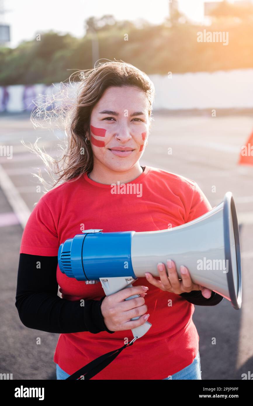 Fan of a team with a megaphone and a sad face for the defeat of her ...