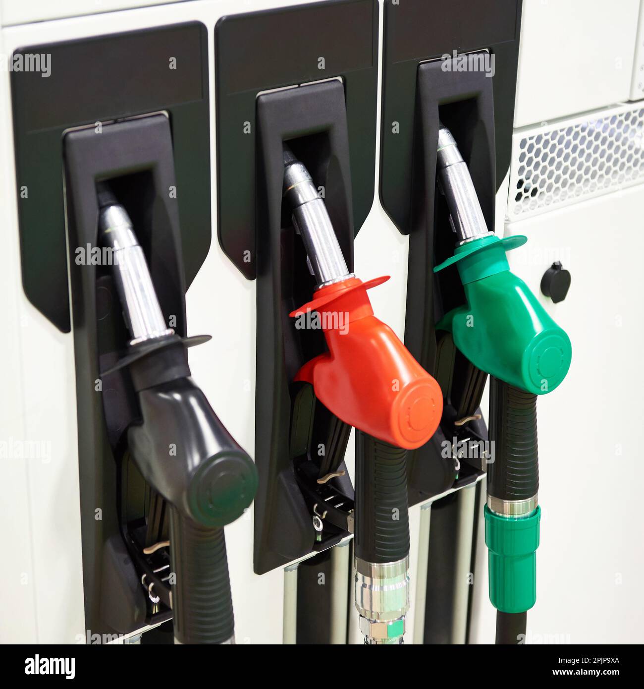 Fuel nozzles on filling station Stock Photo - Alamy