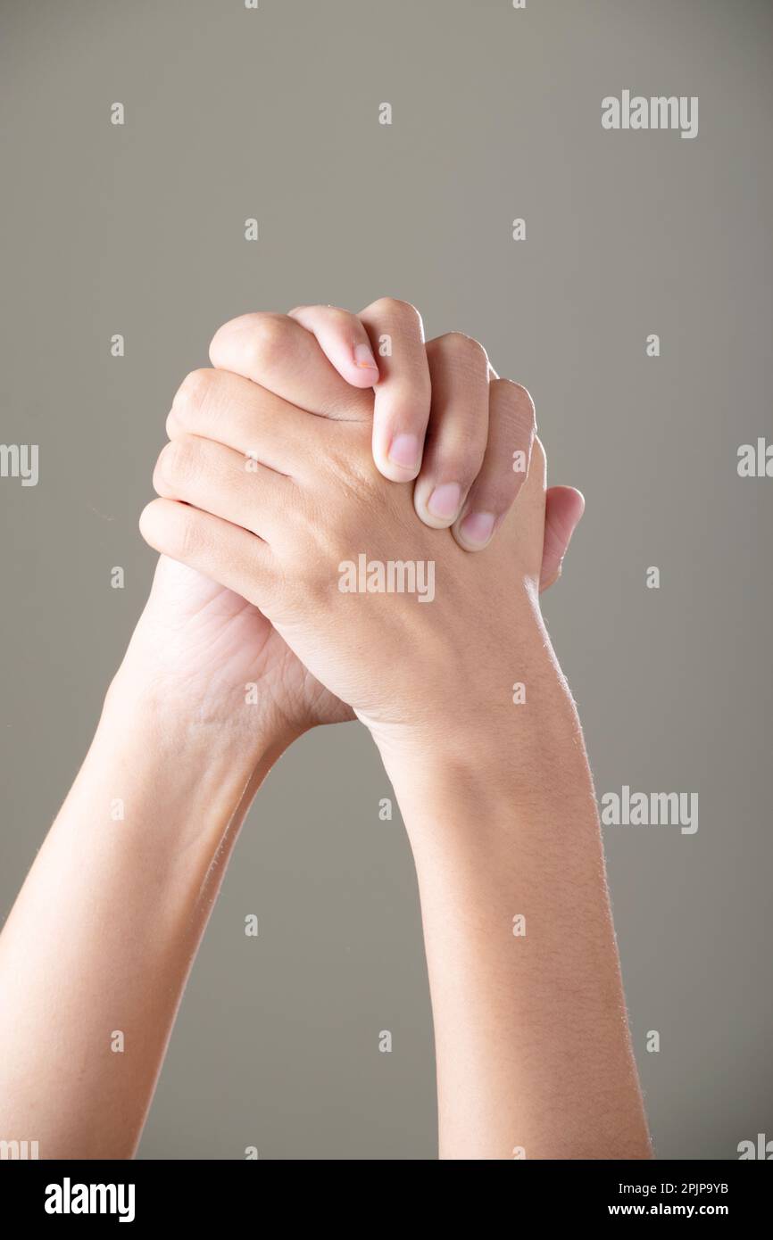 Unity and hope hand gesture on grey background Stock Photo - Alamy