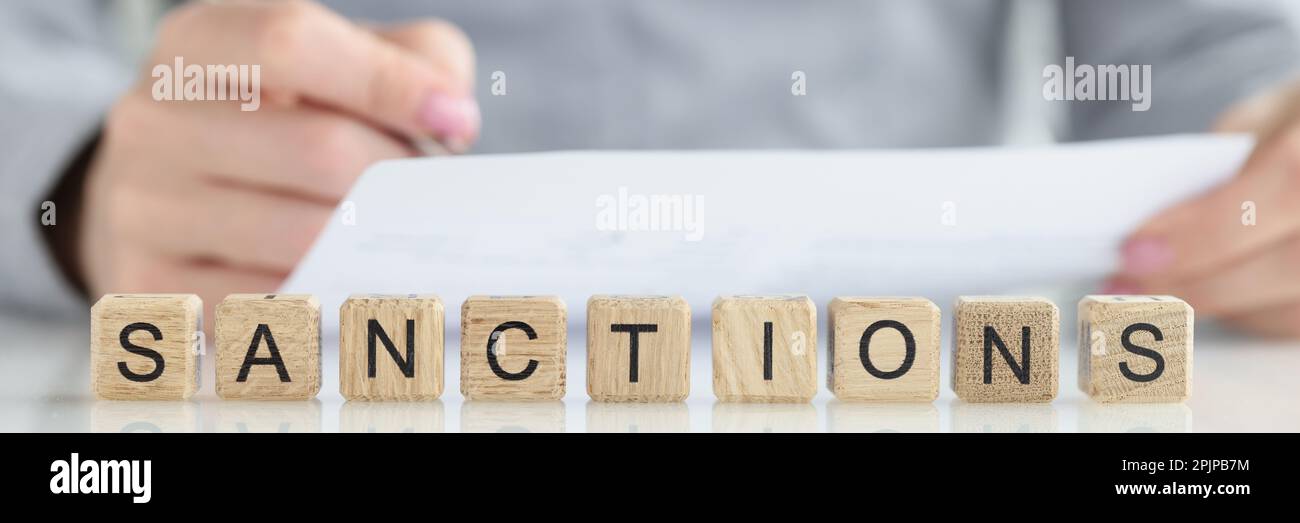 Text sanctions list on white note paper Stock Photo - Alamy