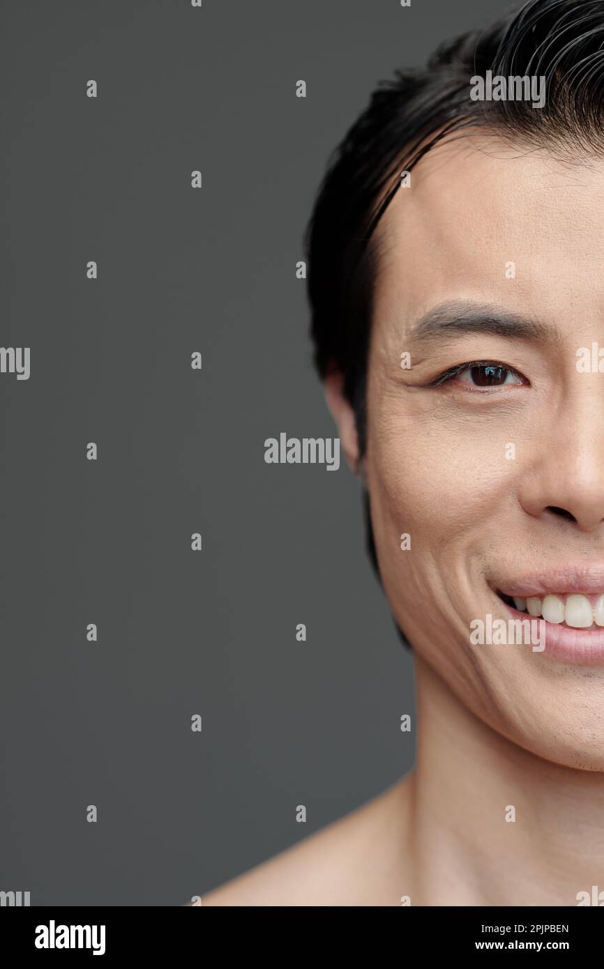 Half face of smiling Japanese man looking at camera Stock Photo - Alamy