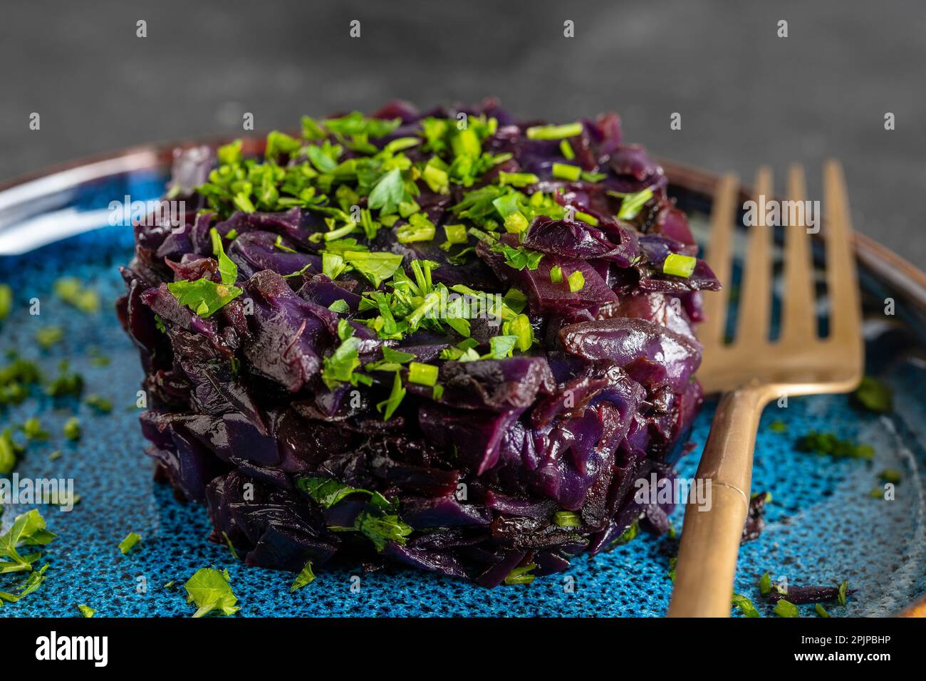 Fried red cabbage stewed in mulled wine served in plate. Background of ...