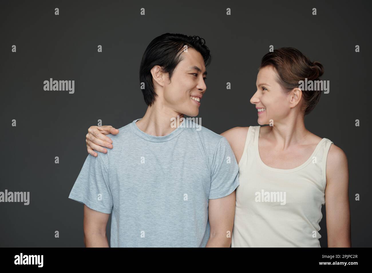 Happy diverse couple in love looking at each other Stock Photo - Alamy