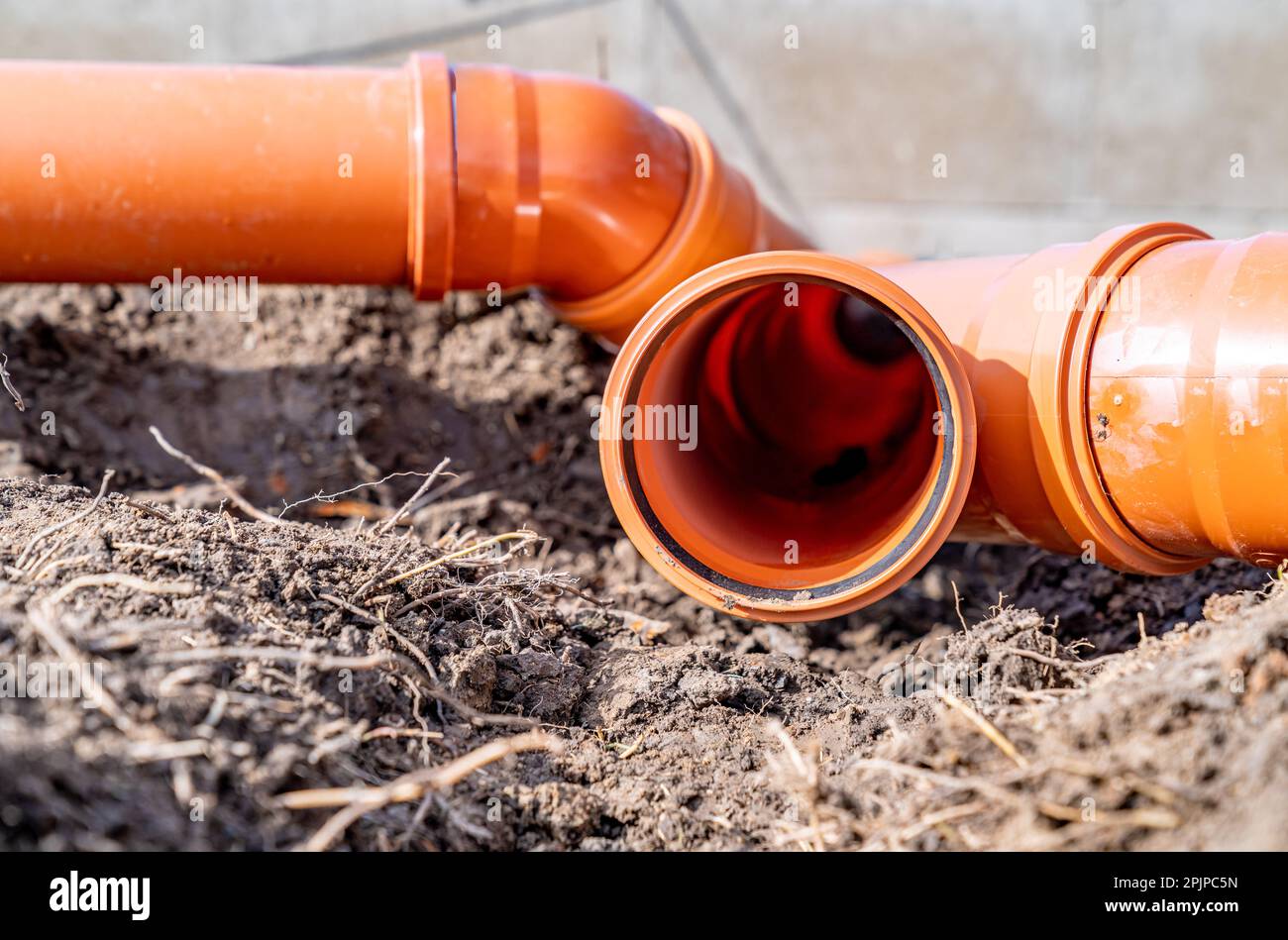 PVC plastic pipe for sewerage in the ground Stock Photo - Alamy