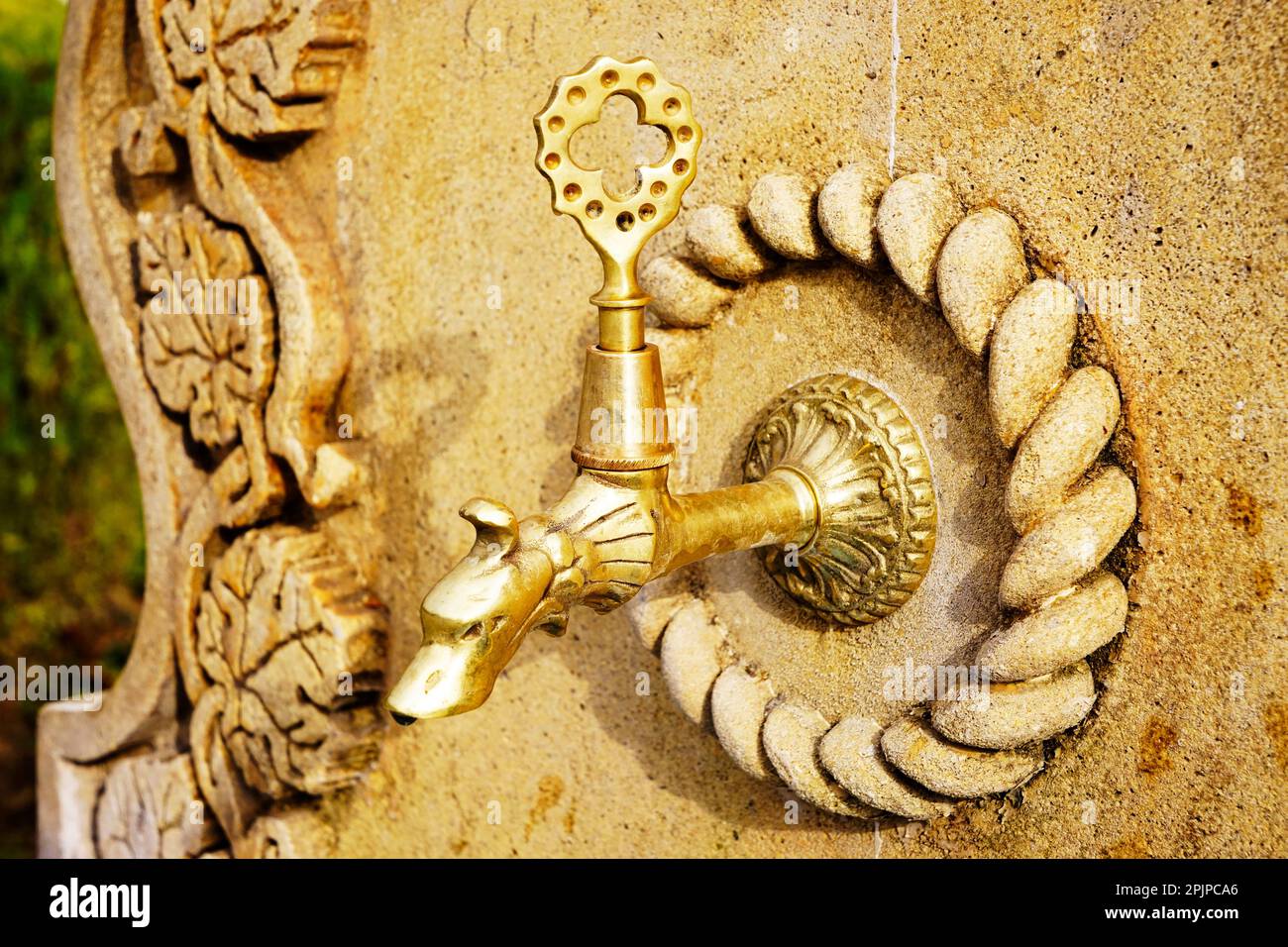 Drinking fountain. An ancient urban drinking fountain in an old marble ...