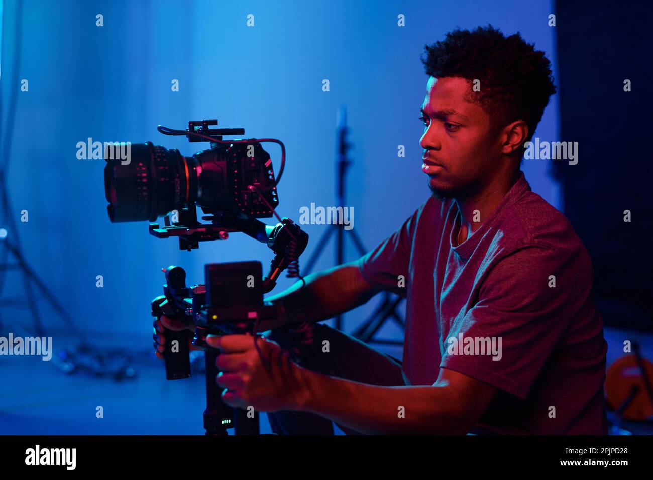 African American operator concentrating on his work, he using camera on ...