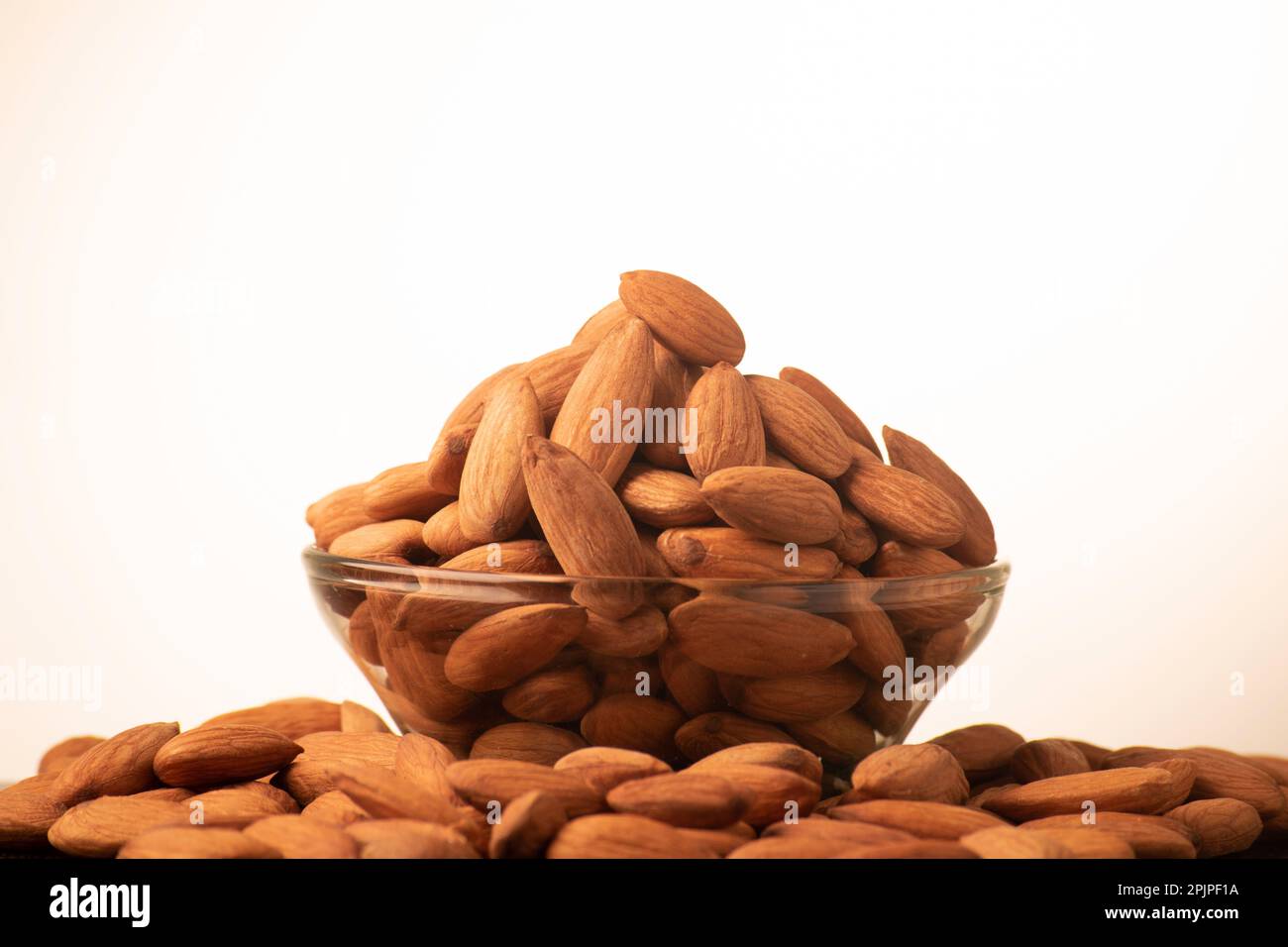 Almond in bowl on white background for packaging and advertising Stock ...