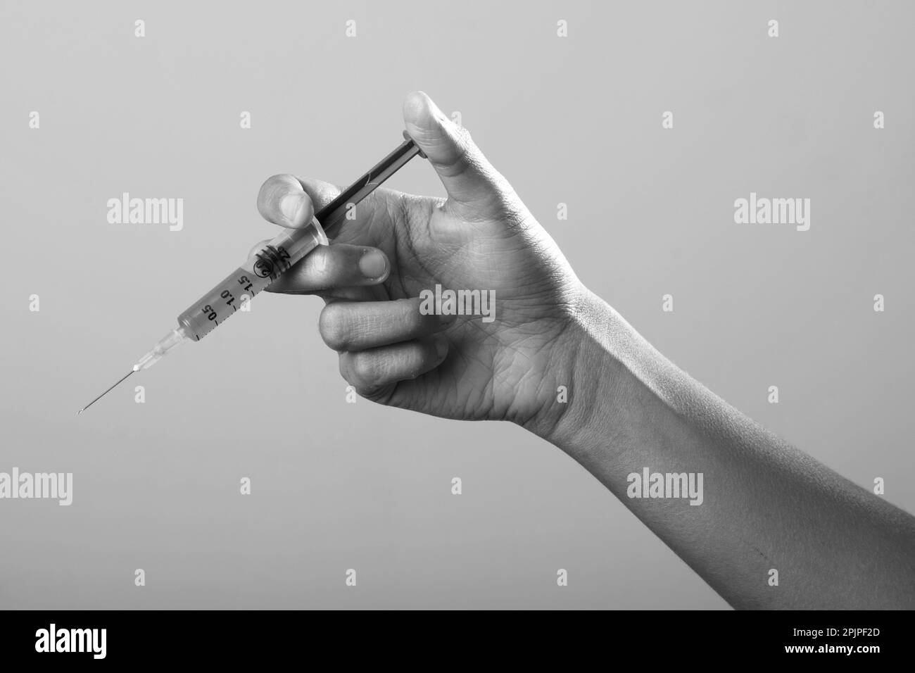 Hand Holding injection black and white image Stock Photo - Alamy