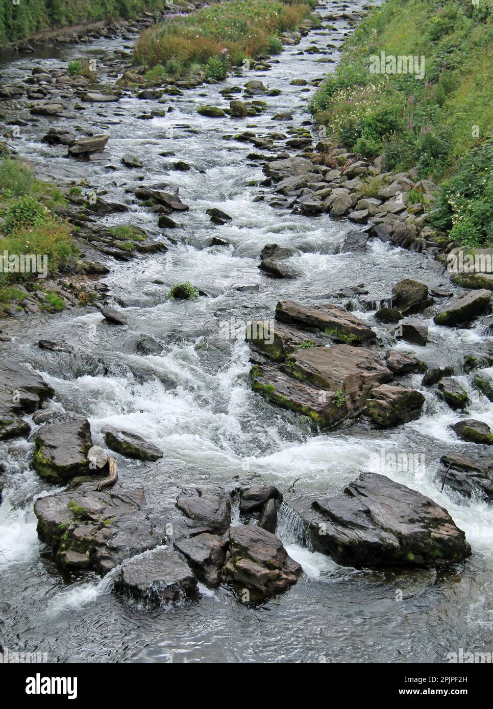 A Large Stream Running Over a Rocky Riverbed Stock Photo - Alamy