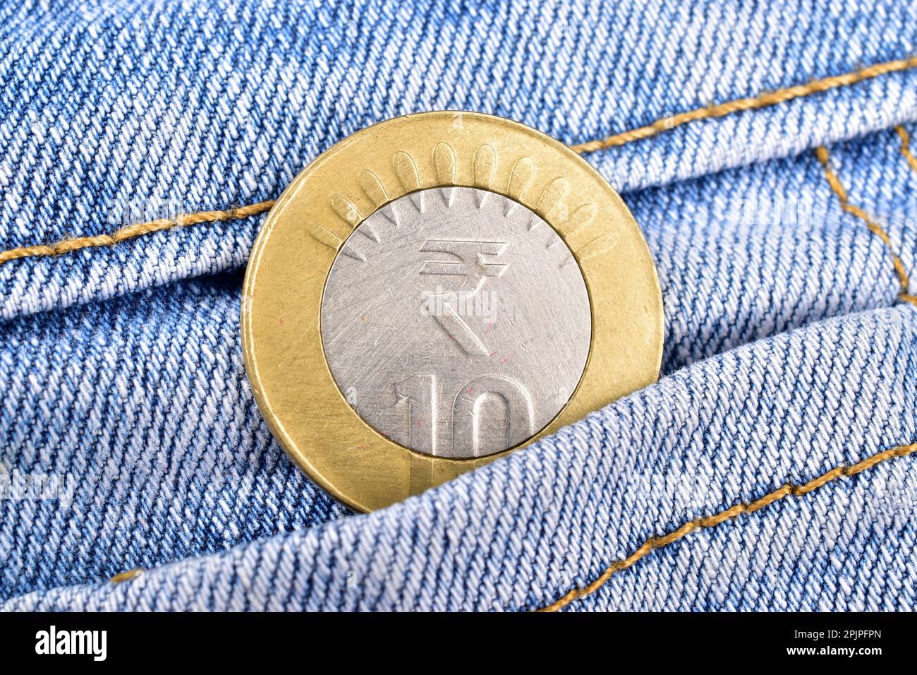 Closeup of ten rupee coin in pocket small savings concept Stock Photo ...