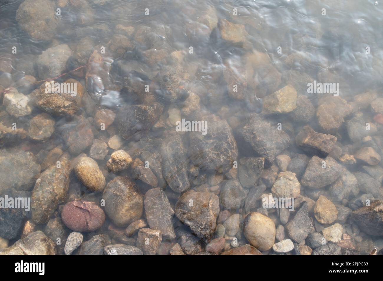 Top view of river water stone texture background Stock Photo - Alamy