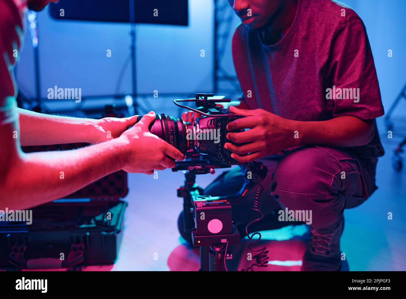 Young operator setting the camera with his assistant before shooting ...