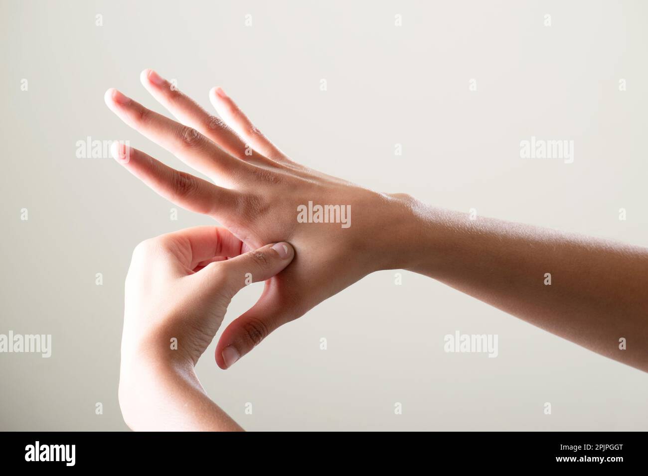 Female hand acupressure pressing palm pain on grey background Stock ...