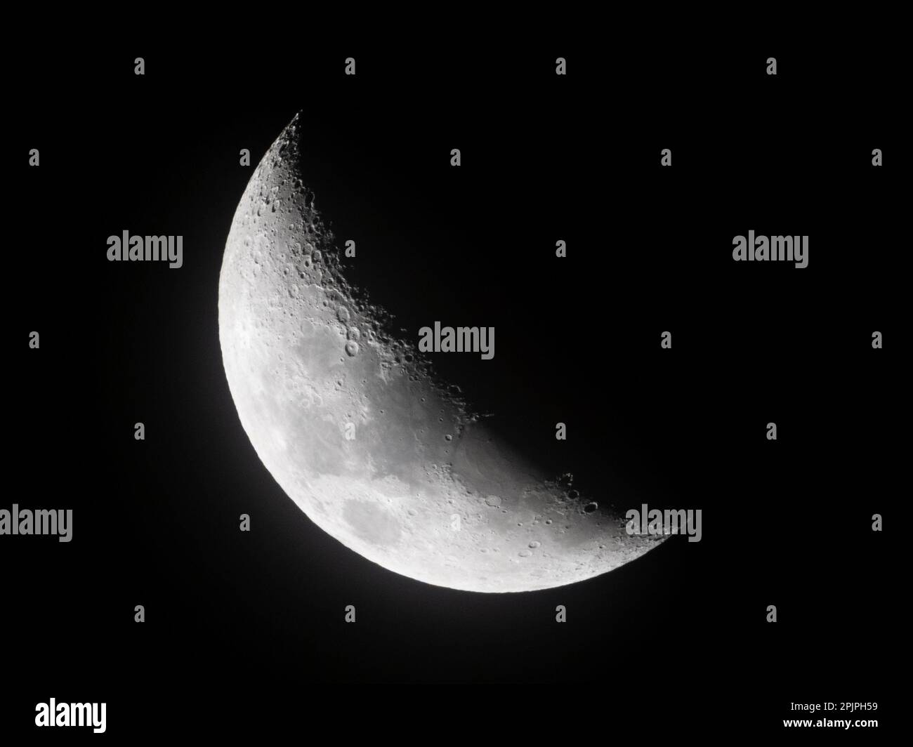 A black and white photograph featuring a distant view of the moon in ...