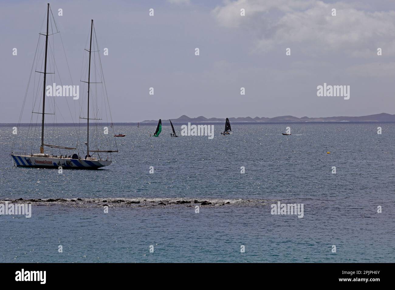 Sailing boats at moorings and sailing team boats with black sails ...