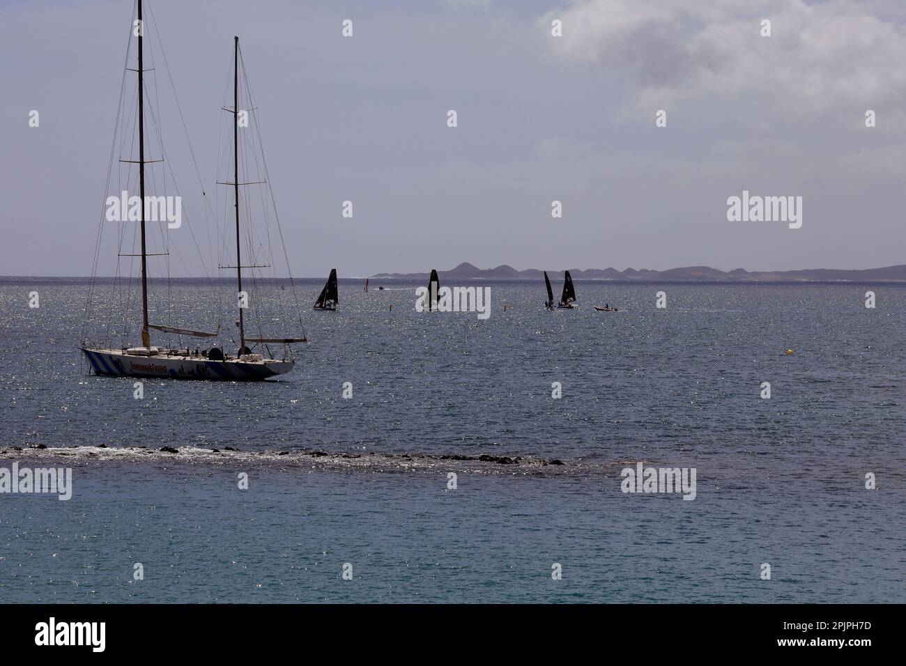 Sailing boats at moorings and sailing team boats with black sails ...