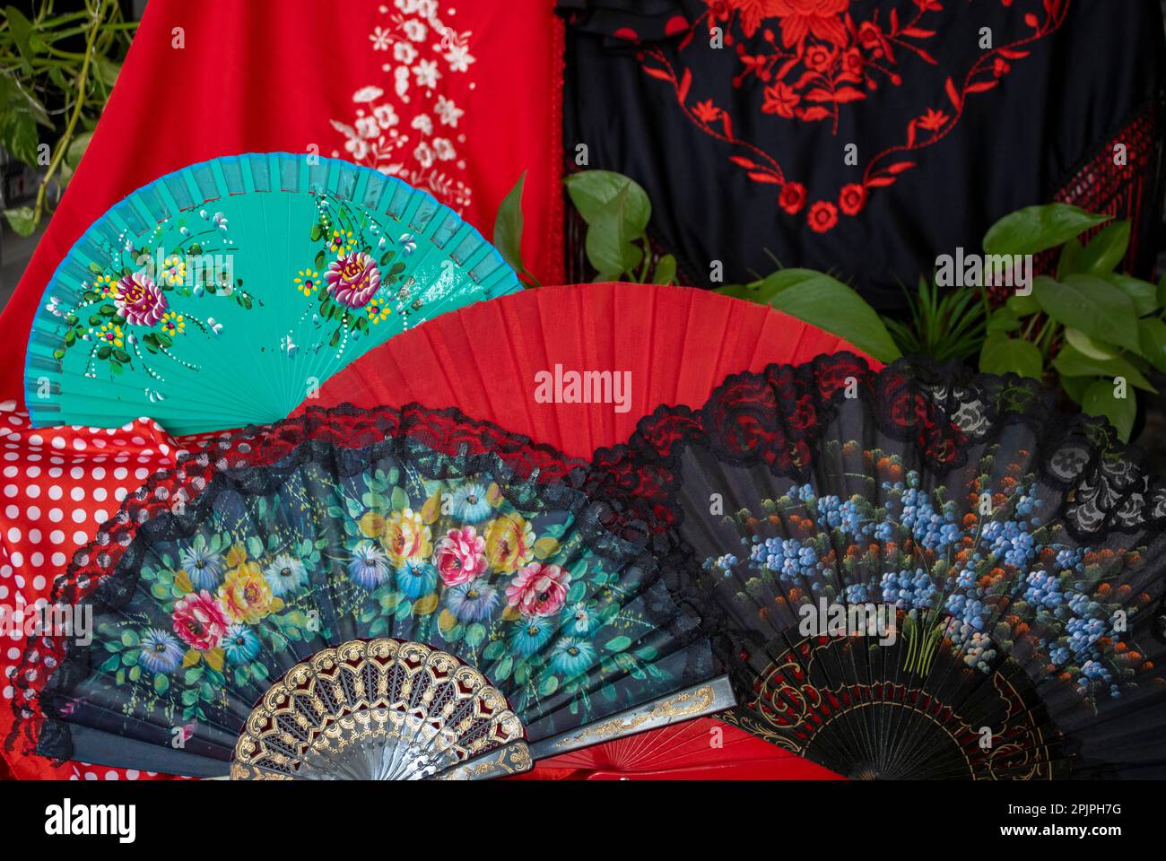 Close-up fans of different colors, red and black with flowers and lace ...