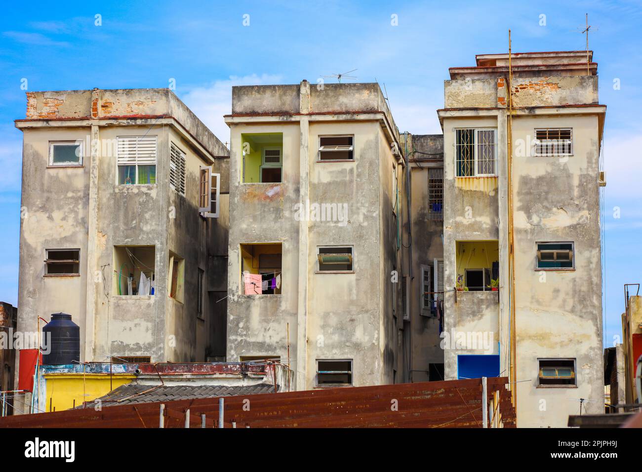 A row of aging brick buildings situated in a poverty-stricken area ...