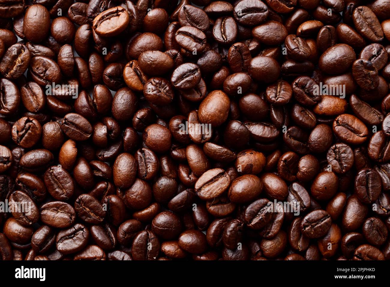 Top view of roasted coffee bean texture background Stock Photo - Alamy