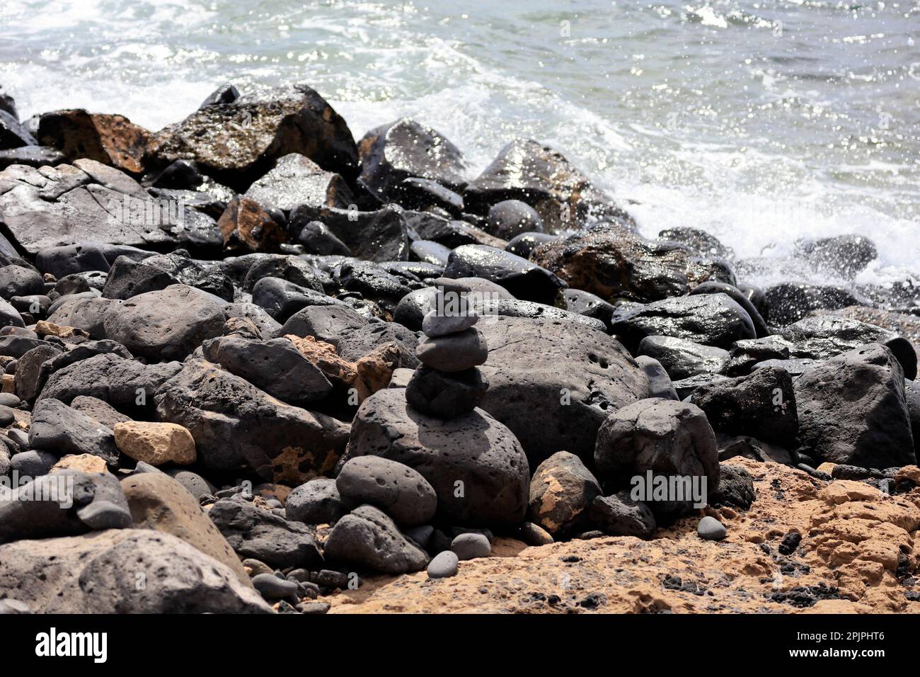 Stacked stones on a beach. Lanzarote. February 2023 Stock Photo - Alamy