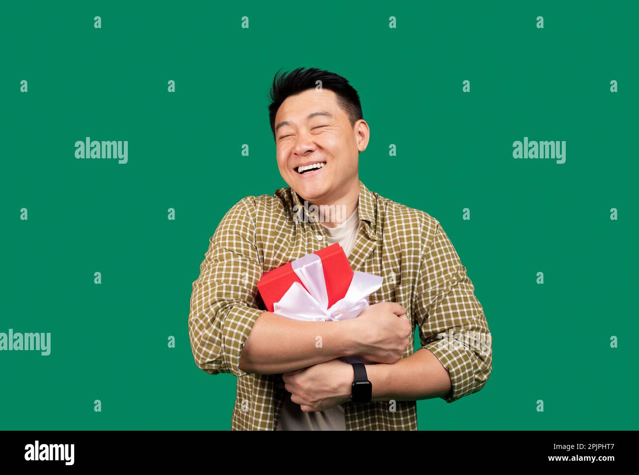 Best birthday gift. Happy asian man hugging wrapped present box and ...