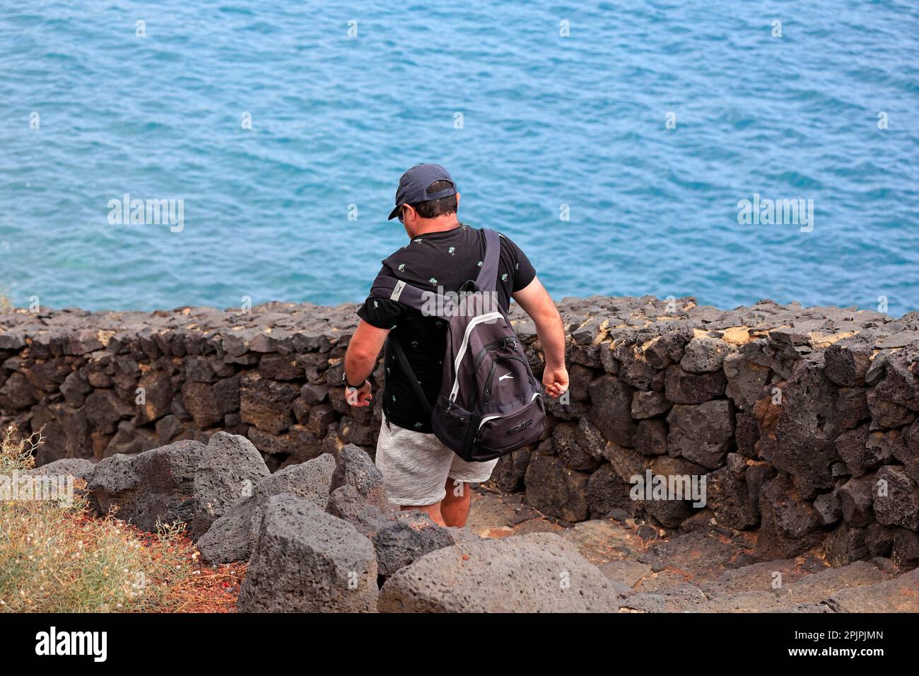 Man enjoying walking on the coastal path between Playa Blanca and Las ...