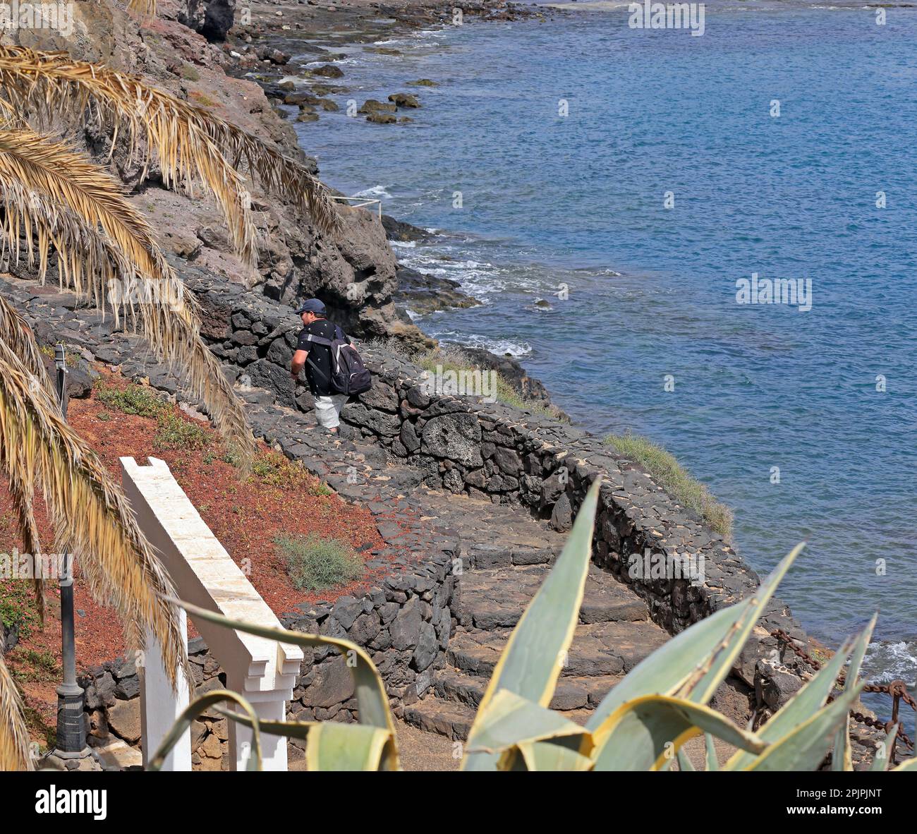 Man enjoying walking on the coastal path between Playa Blanca and Las ...