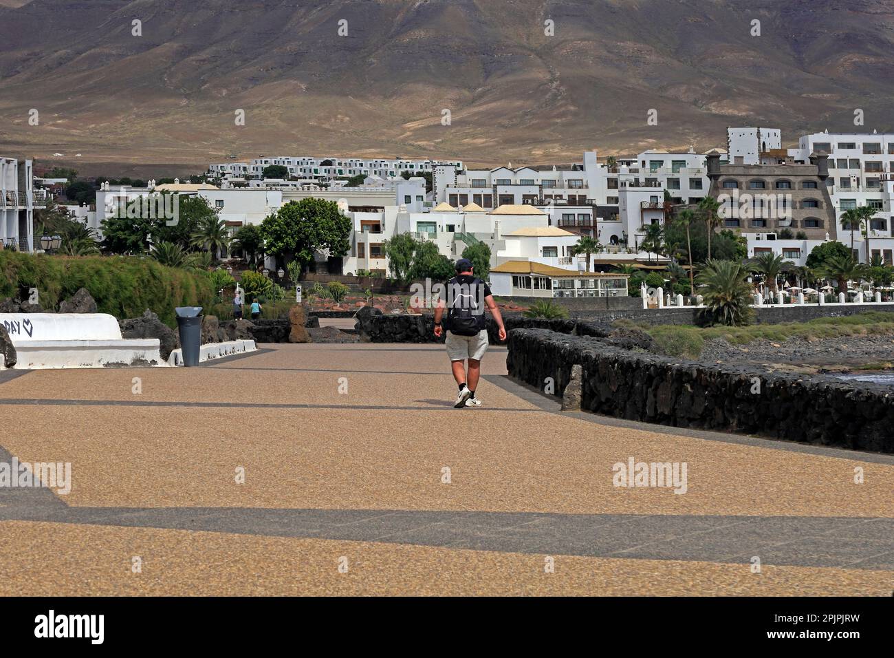 Man enjoying walking on the coastal path between Playa Blanca and Las ...