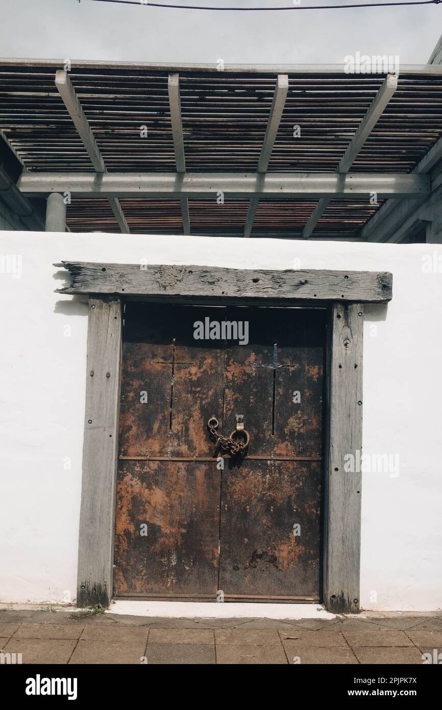 An old, rusty metal door with a unique patina of age set against a ...