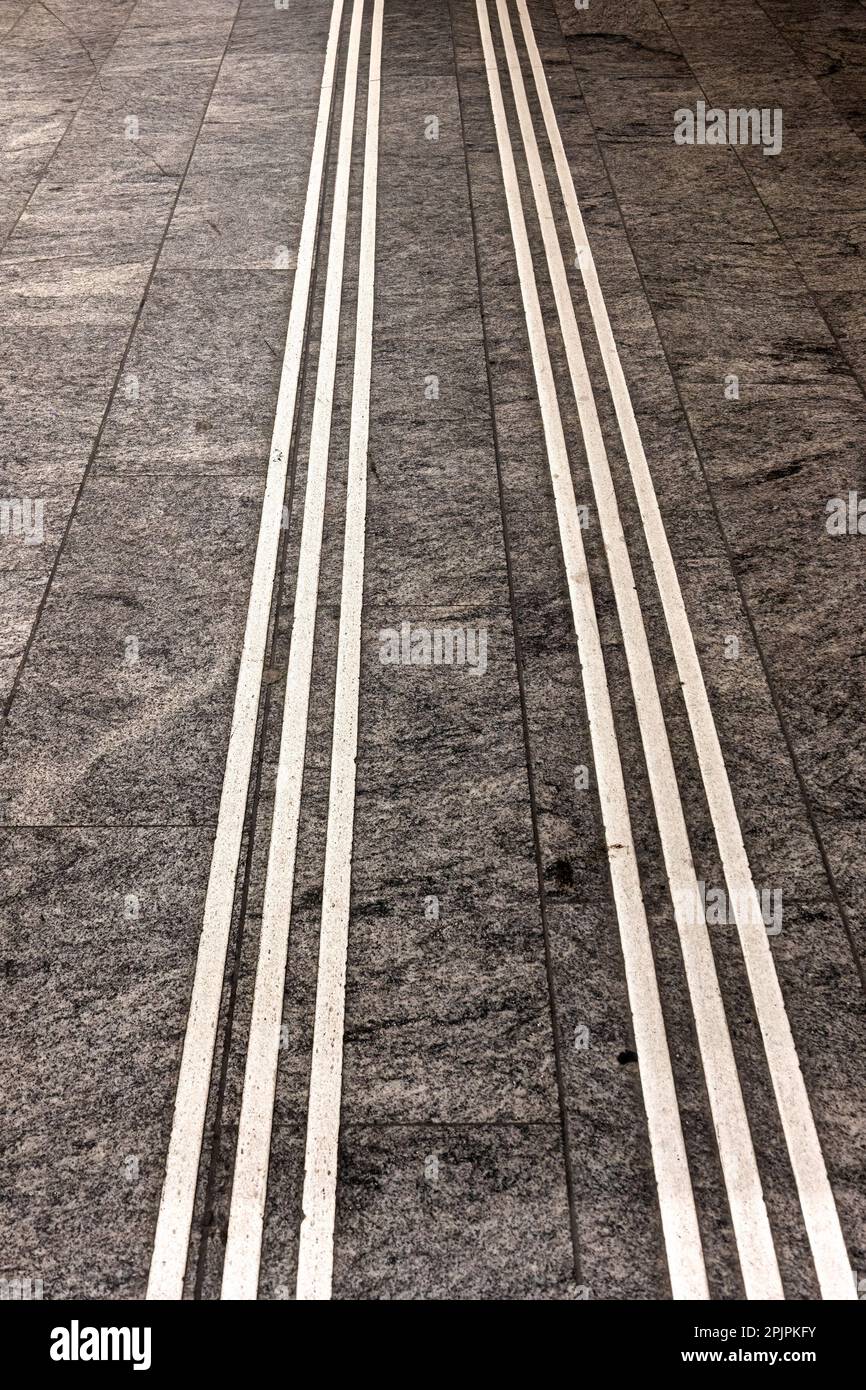 White lines on grey stone floor tiles for use as a background texture ...