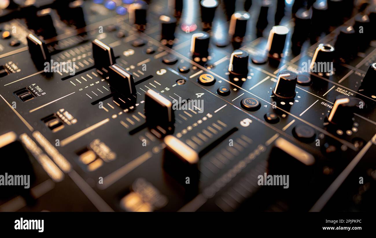 A detailed closeup of the knobs and buttons on a professional audio ...