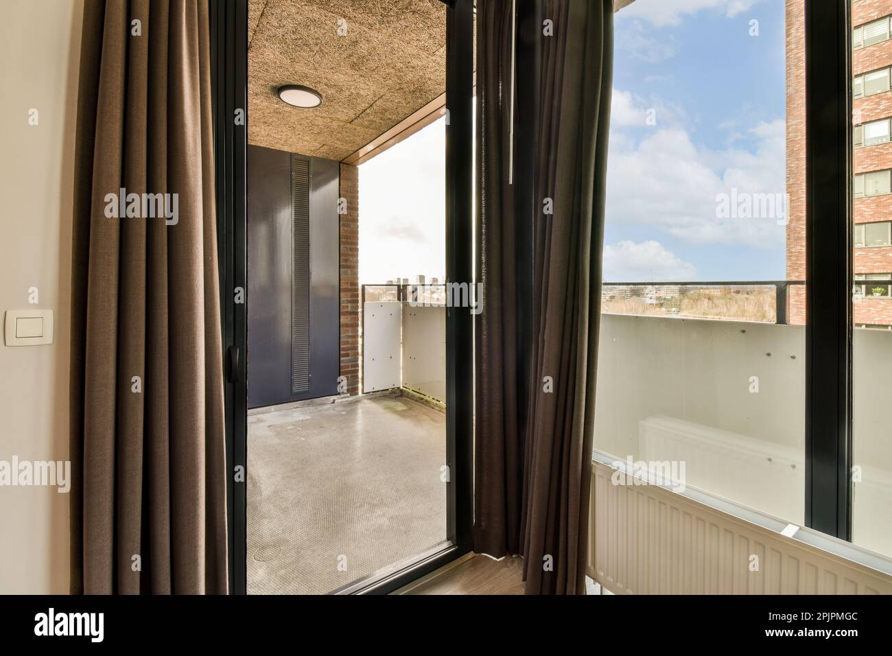 an outside view from inside a room with curtains on the windows and ...