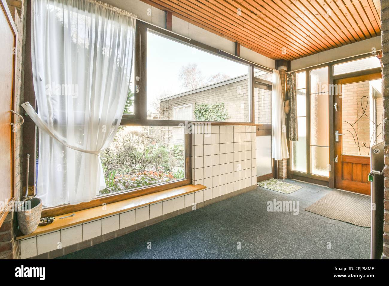 the inside of a room with a window and some plants on the outside, in ...