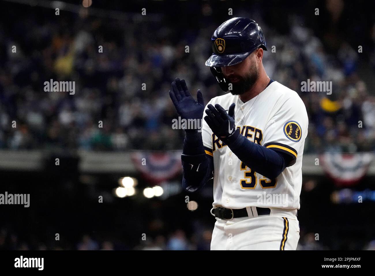 Milwaukee Brewers' Jesse Winker claps after hitting an RBI single ...