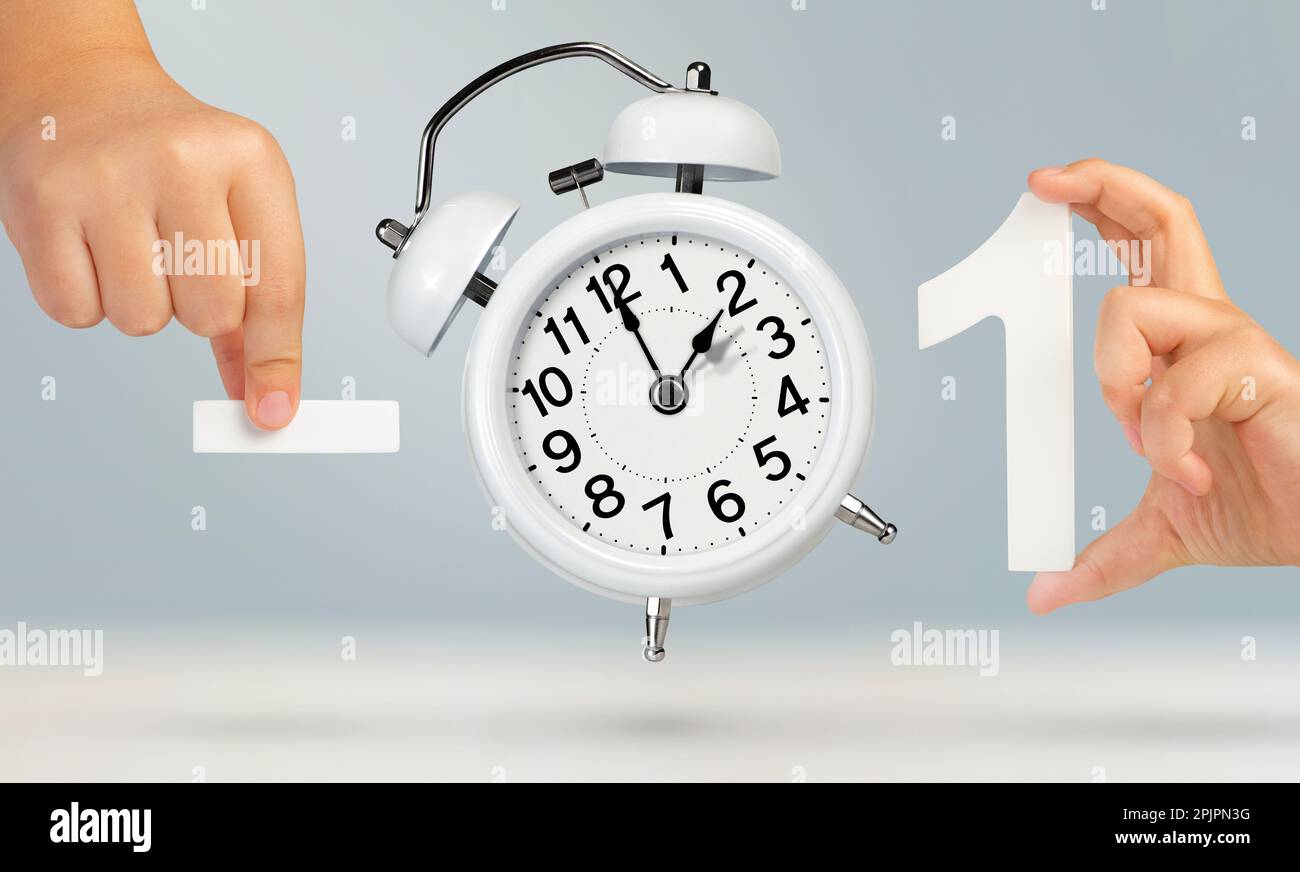 Change time, minus one hour. Fall back, on a gray background. A white ...