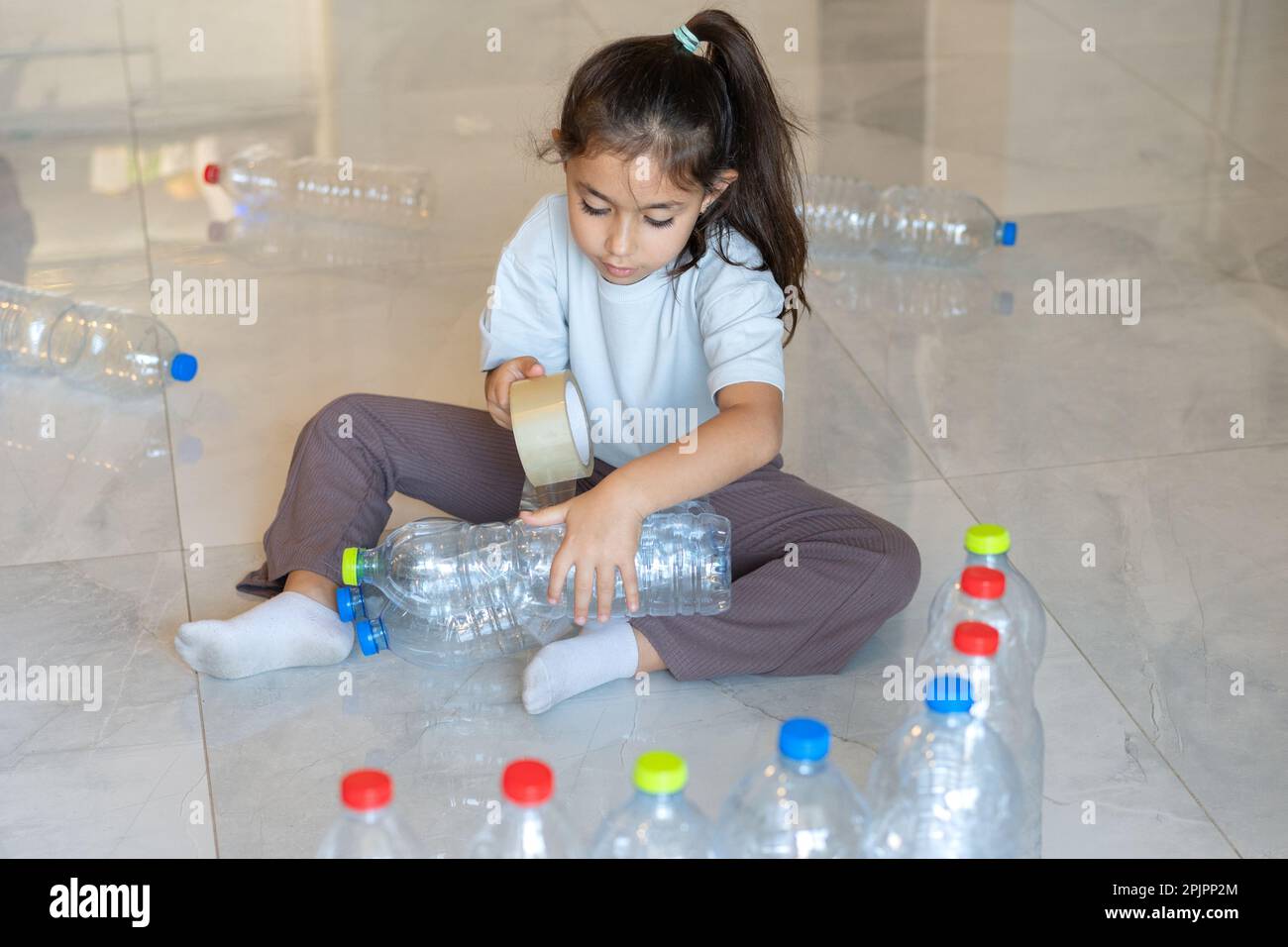 Fun DIY Project for Kids: Girl Engaged in Creative Play with Plastic ...