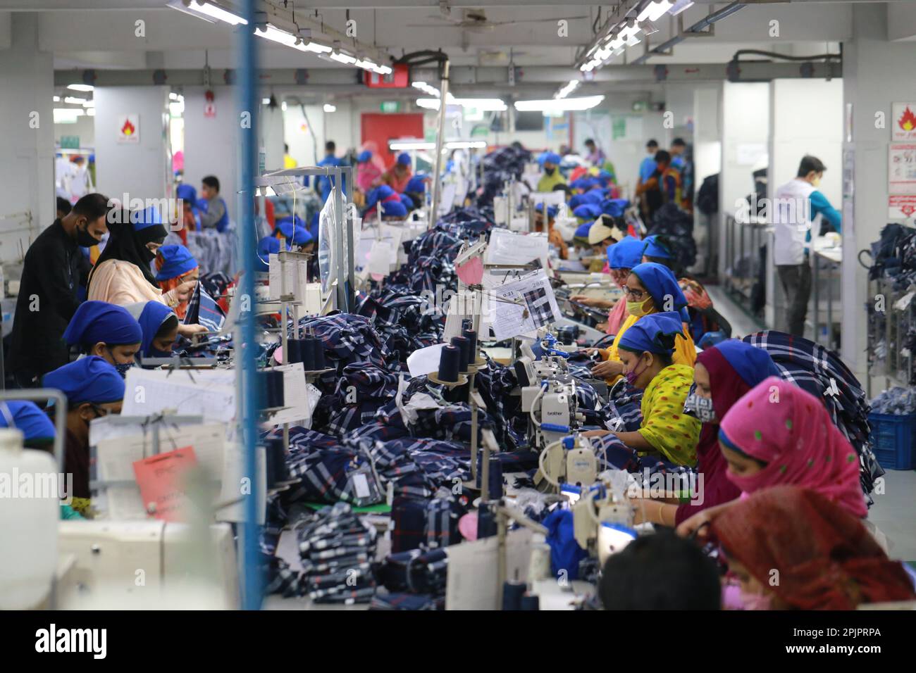 Garment workers work at a ready-made garment factory in Bangladesh ...