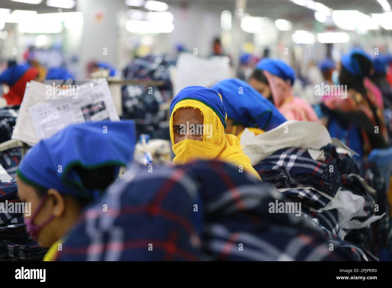 Garment workers work at a ready-made garment factory in Bangladesh ...